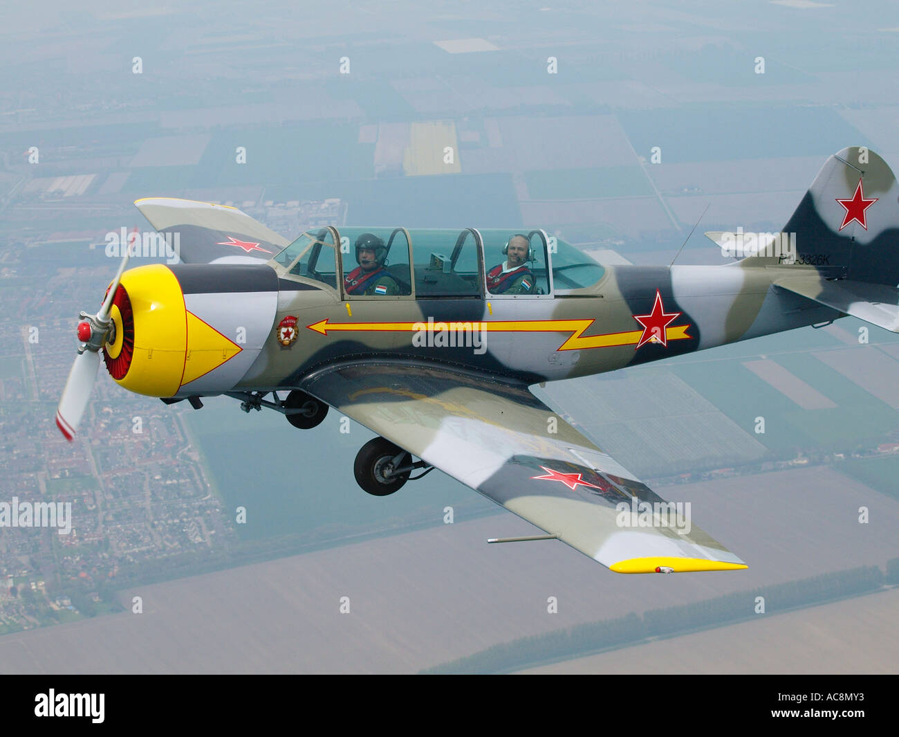 Yakovlev Yak 52 Russian two seater trainer aeroplane flying over Noord ...