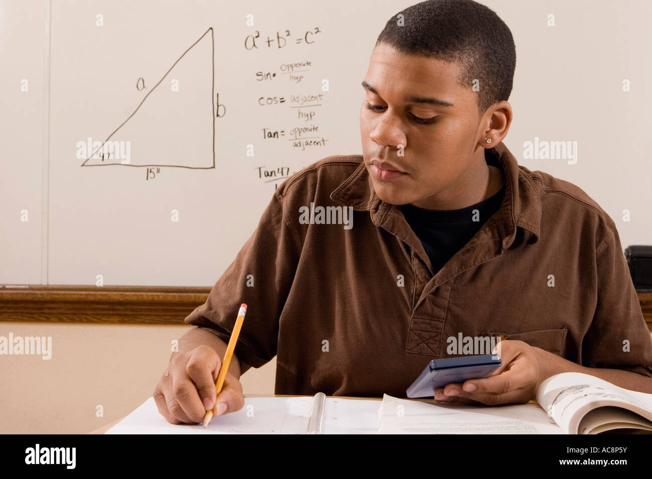 Student writing in a notebook Stock Photo - Alamy
