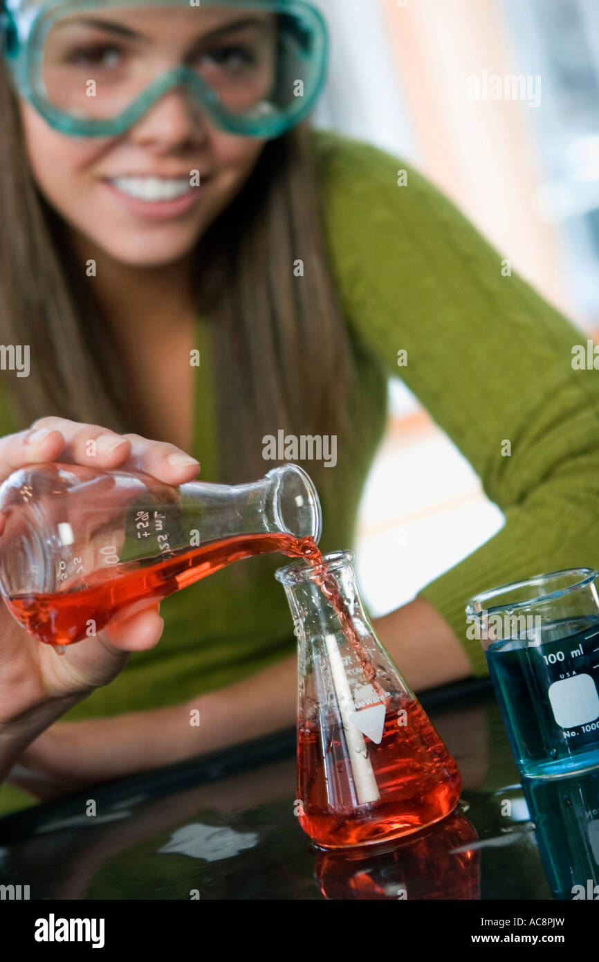 Close-up of a student pouring liquid in a beaker in a science lab Stock ...