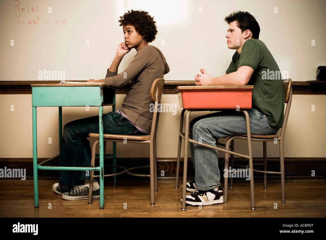 Two students sitting at desks in a classroom Stock Photo - Alamy