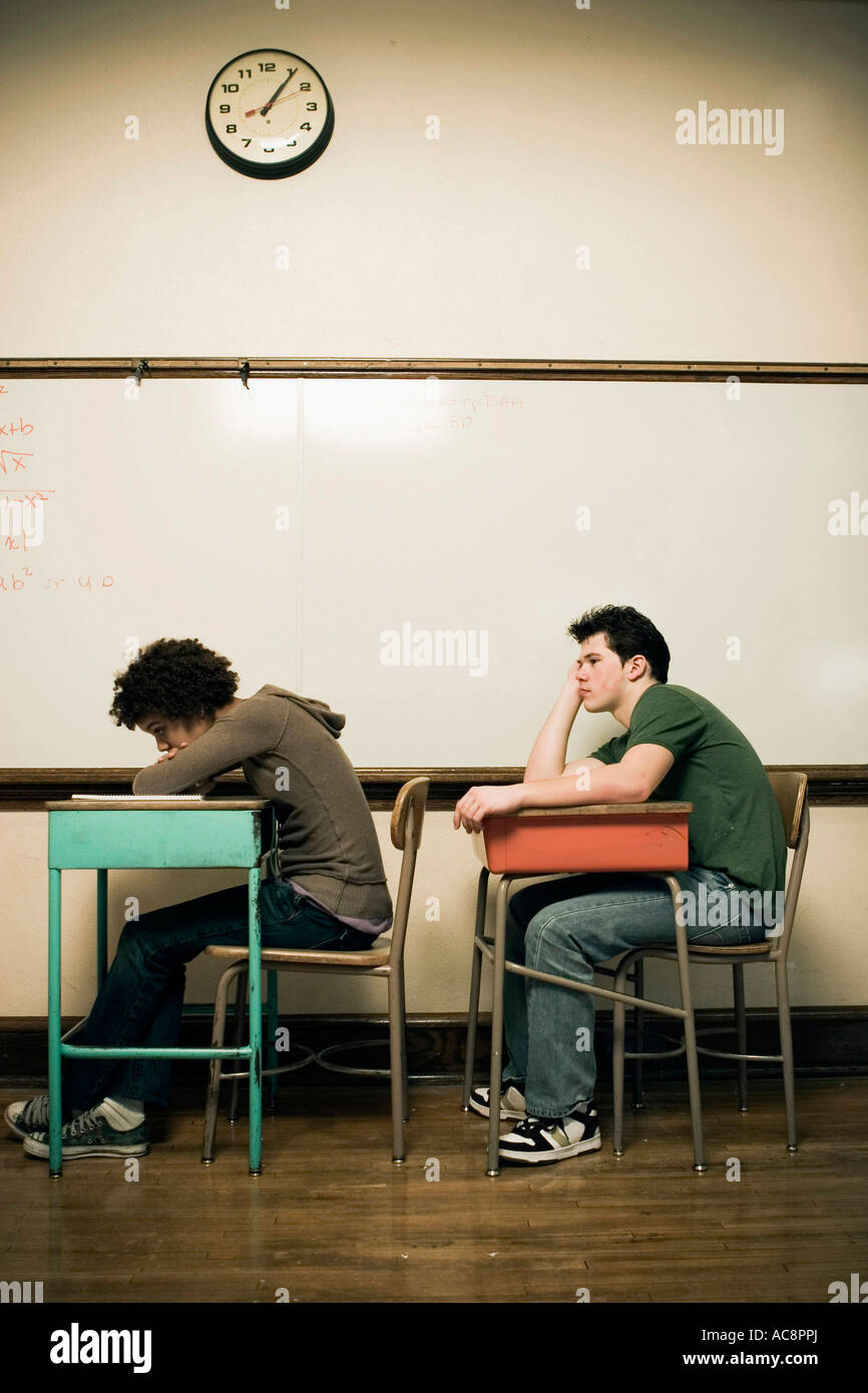 Two students sitting at desks in a classroom Stock Photo - Alamy