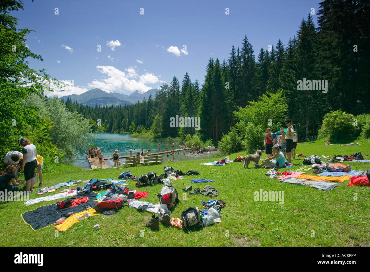 holiday makers relaxing in the sun at Lake Cresta near Flims ...