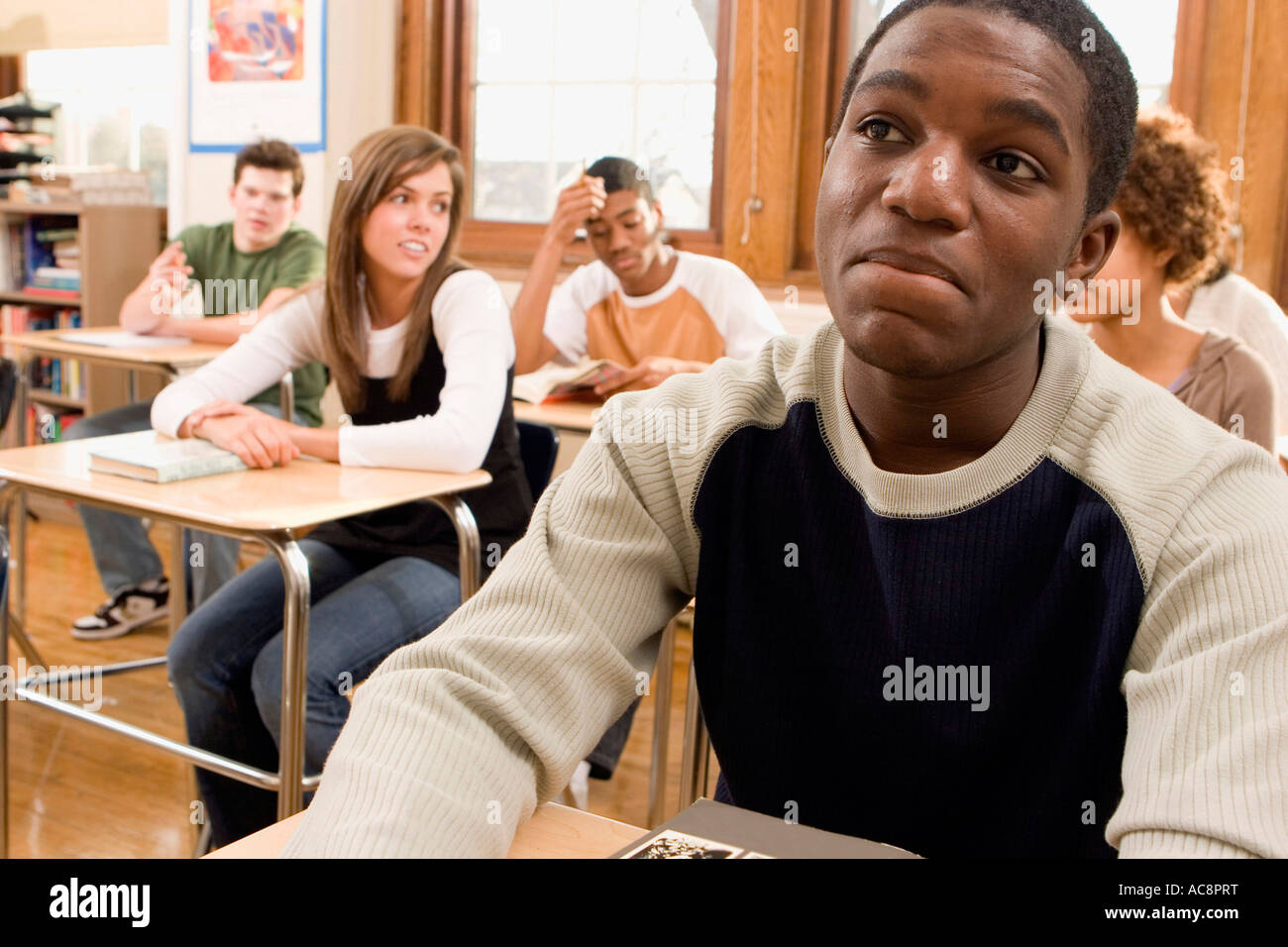 Students sitting at desks in a classroom Stock Photo - Alamy