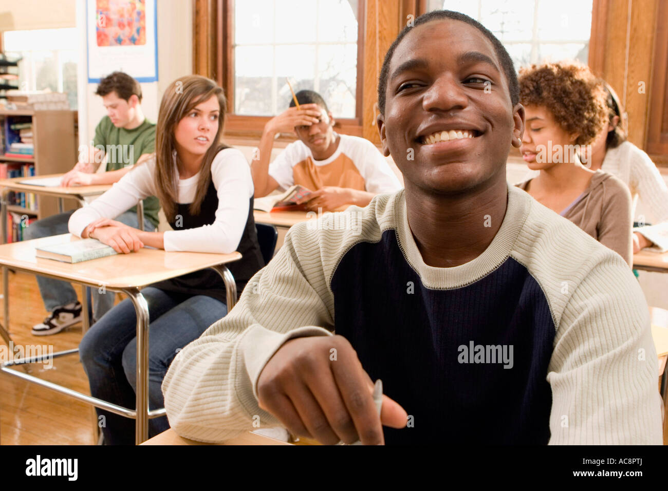 Students sitting at desks in a classroom Stock Photo - Alamy