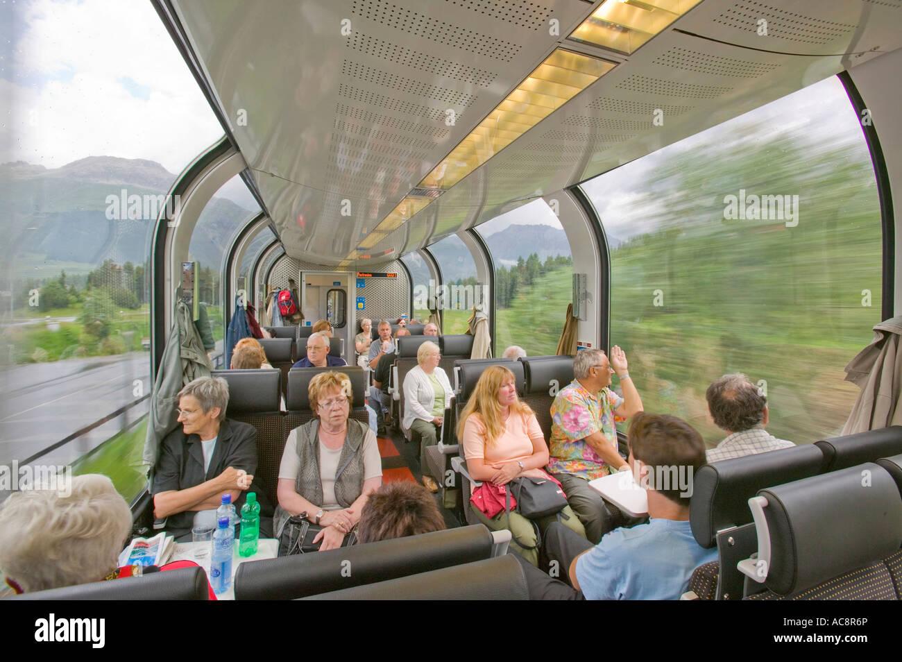 Passengers on the Bernina Express train in Switzerland from Chur to ...