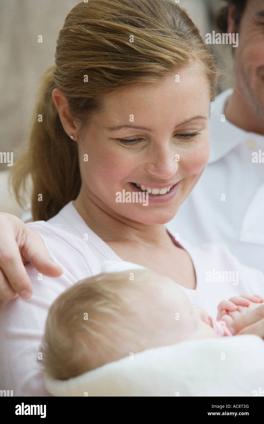 Mid adult woman looking at her baby Stock Photo - Alamy