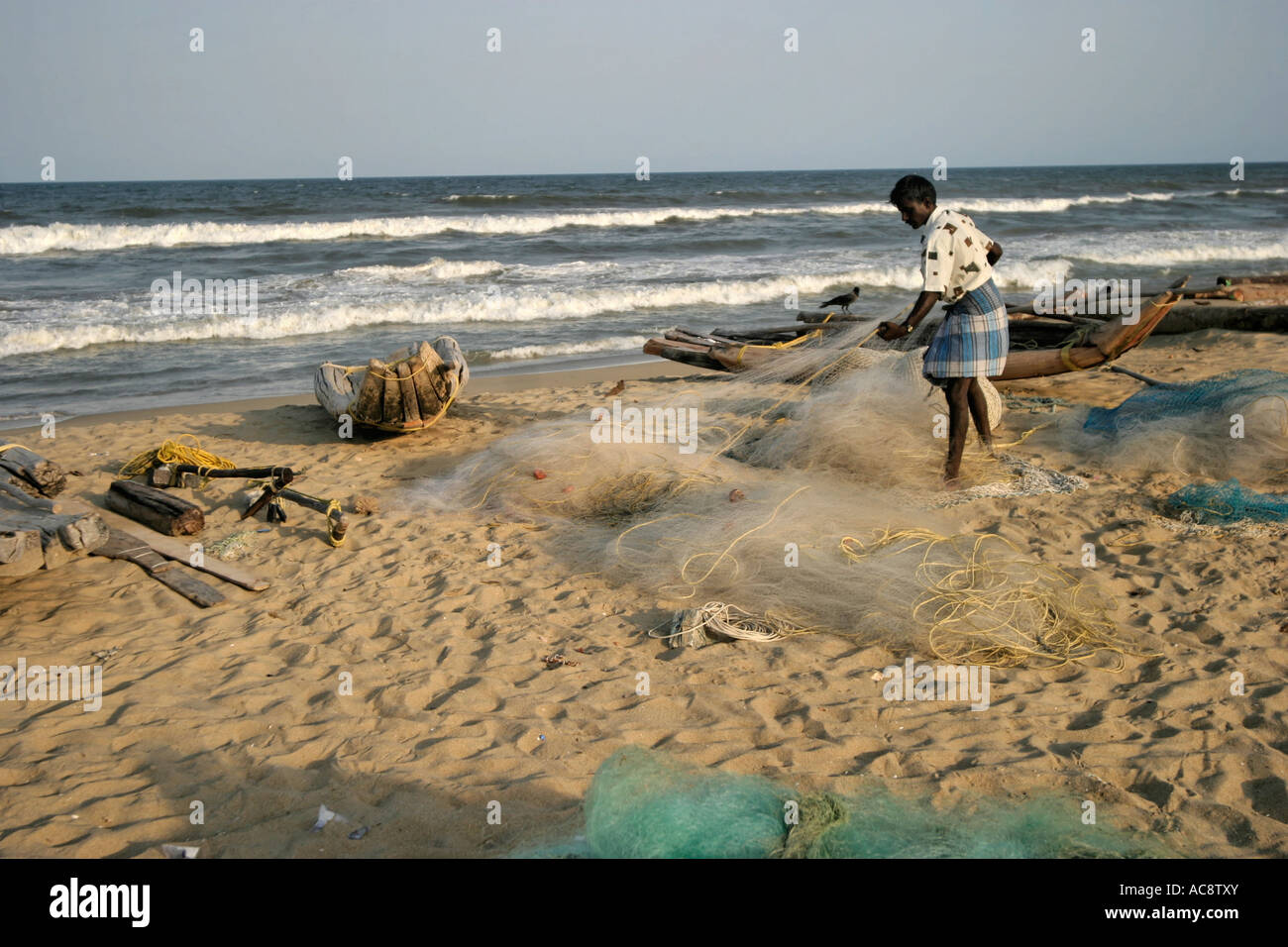 Cleaning nets on beach hi-res stock photography and images - Alamy