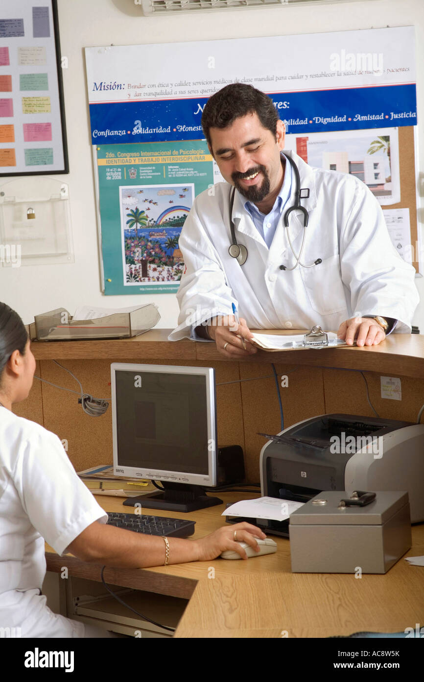 Male doctor standing at a counter and talking to a female nurse Stock ...
