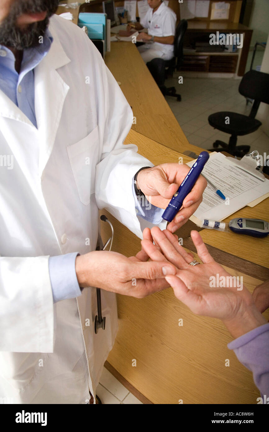 Mid section view of a male doctor taking a blood sample from a patient ...