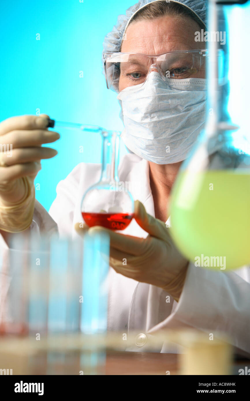 Woman in laboratory filling test tube Stock Photo - Alamy