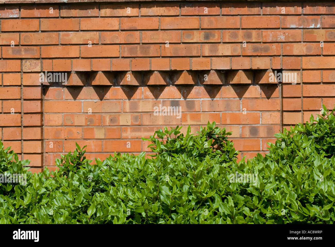 Corbelling in brickwork providing relief pattern on red brick wall ...