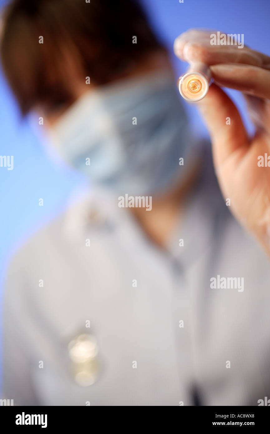 Nurse holding occluder-like torch, studio shot Stock Photo - Alamy