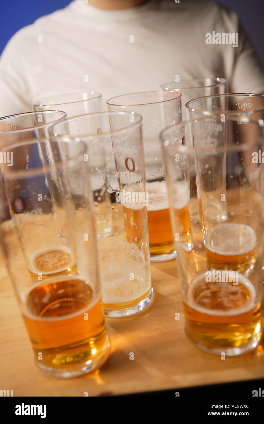 Bar staff clearing empty glasses of beer lager Stock Photo - Alamy