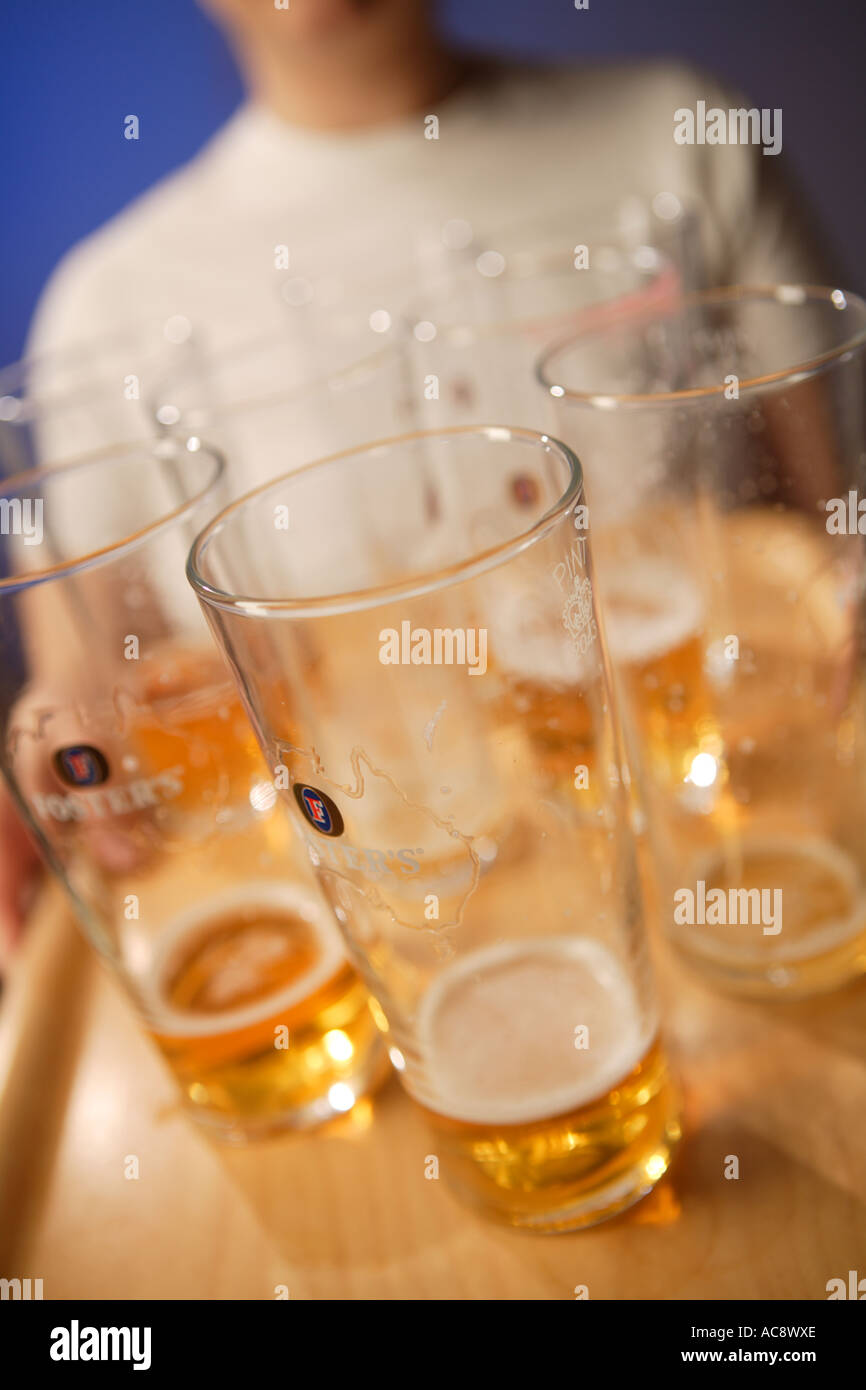 Bar staff clearing empty glasses of beer lager Stock Photo - Alamy