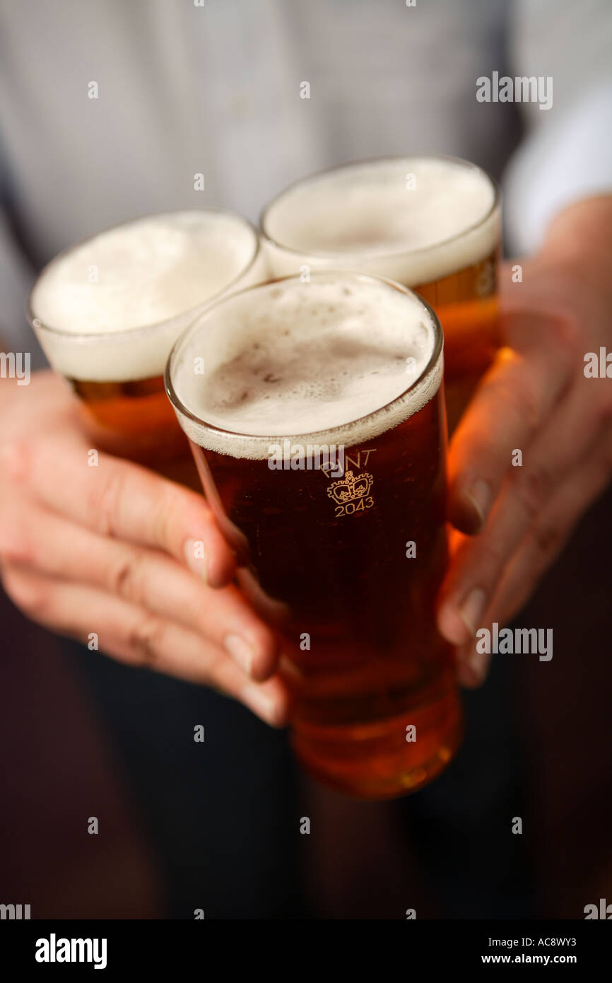 Carrying three pints of lager held together in a triangle Stock Photo ...