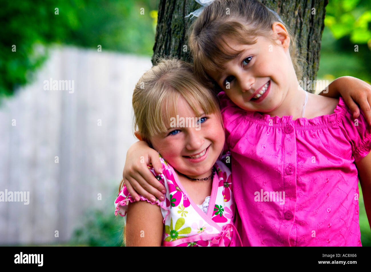 Girls with arms around each other Stock Photo - Alamy