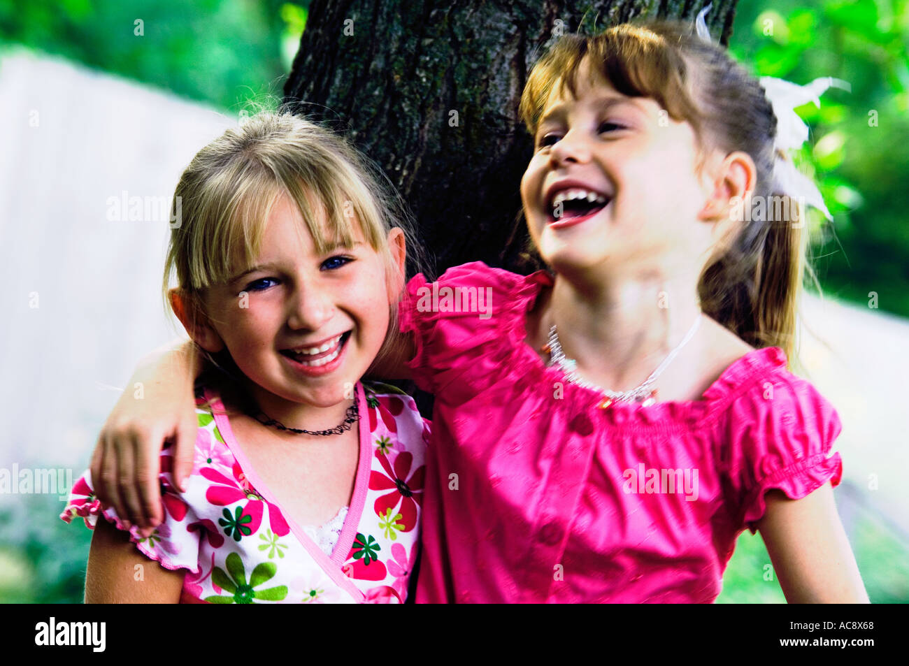 Girls with arms around each other Stock Photo - Alamy