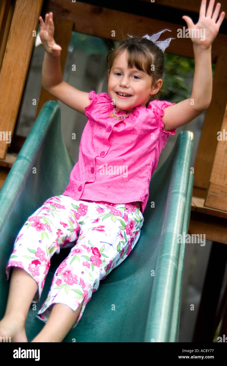 Girl going down slide Stock Photo - Alamy