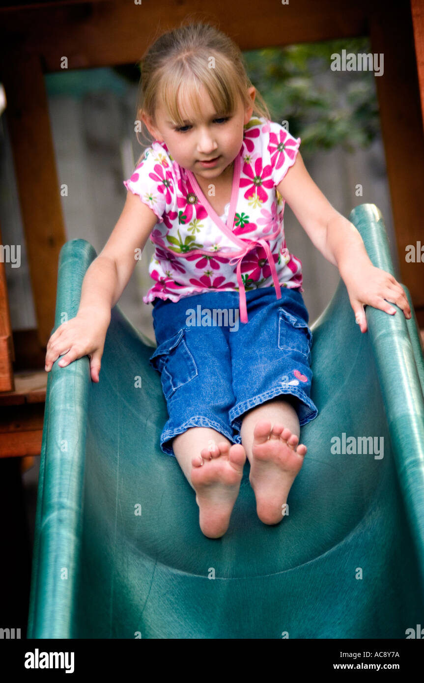Child going down playground slide hi-res stock photography and images ...