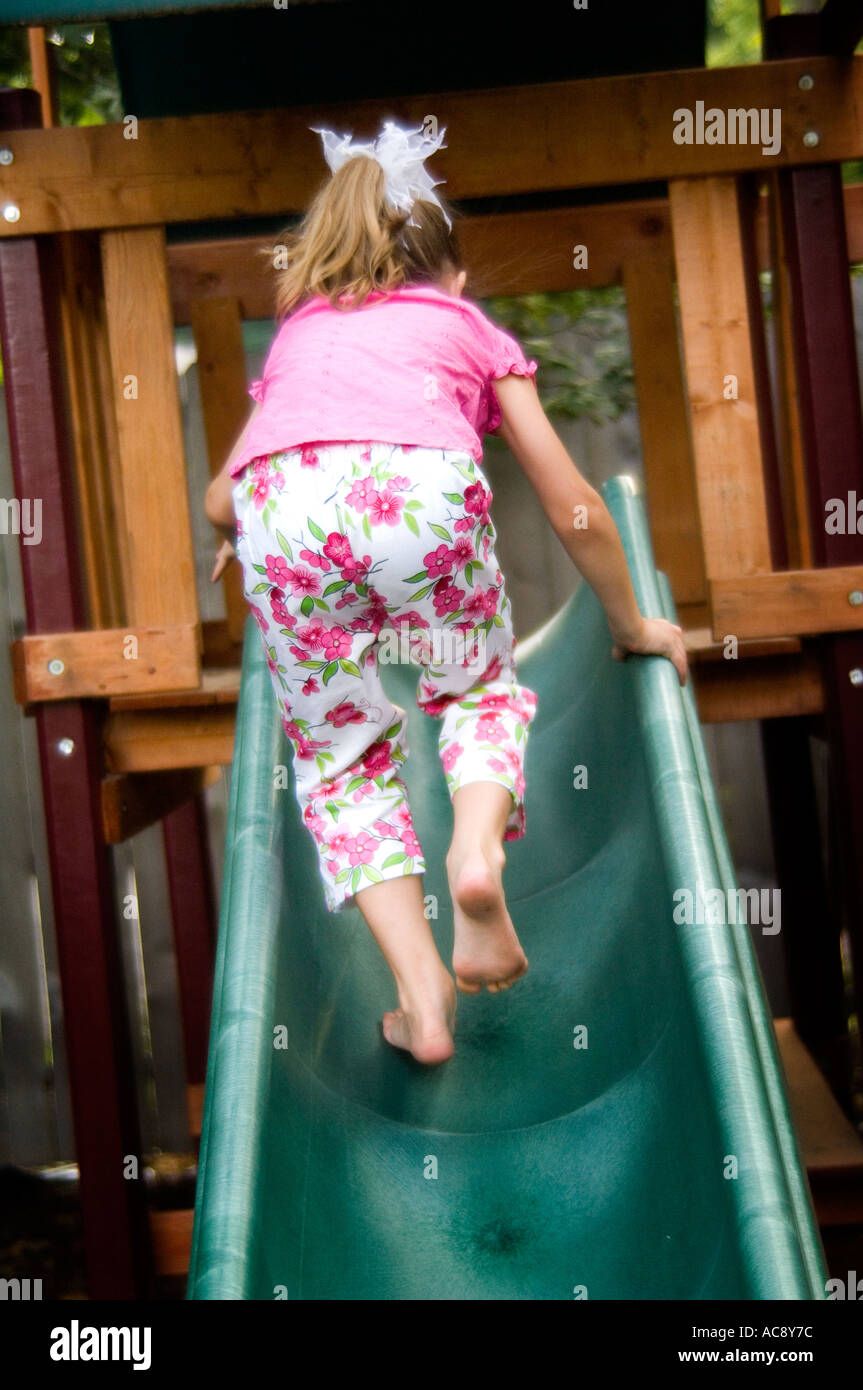 Child climbing up slide hi-res stock photography and images - Alamy