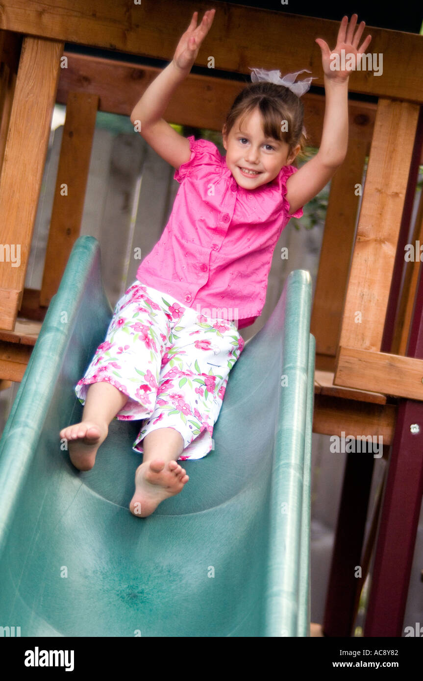 Girl going down slide Stock Photo - Alamy