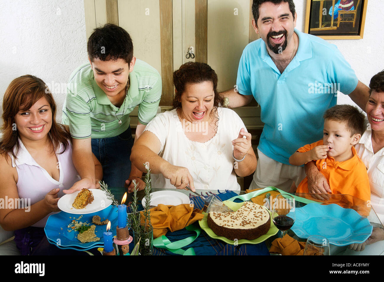 Three generation family around dining table hi-res stock photography ...
