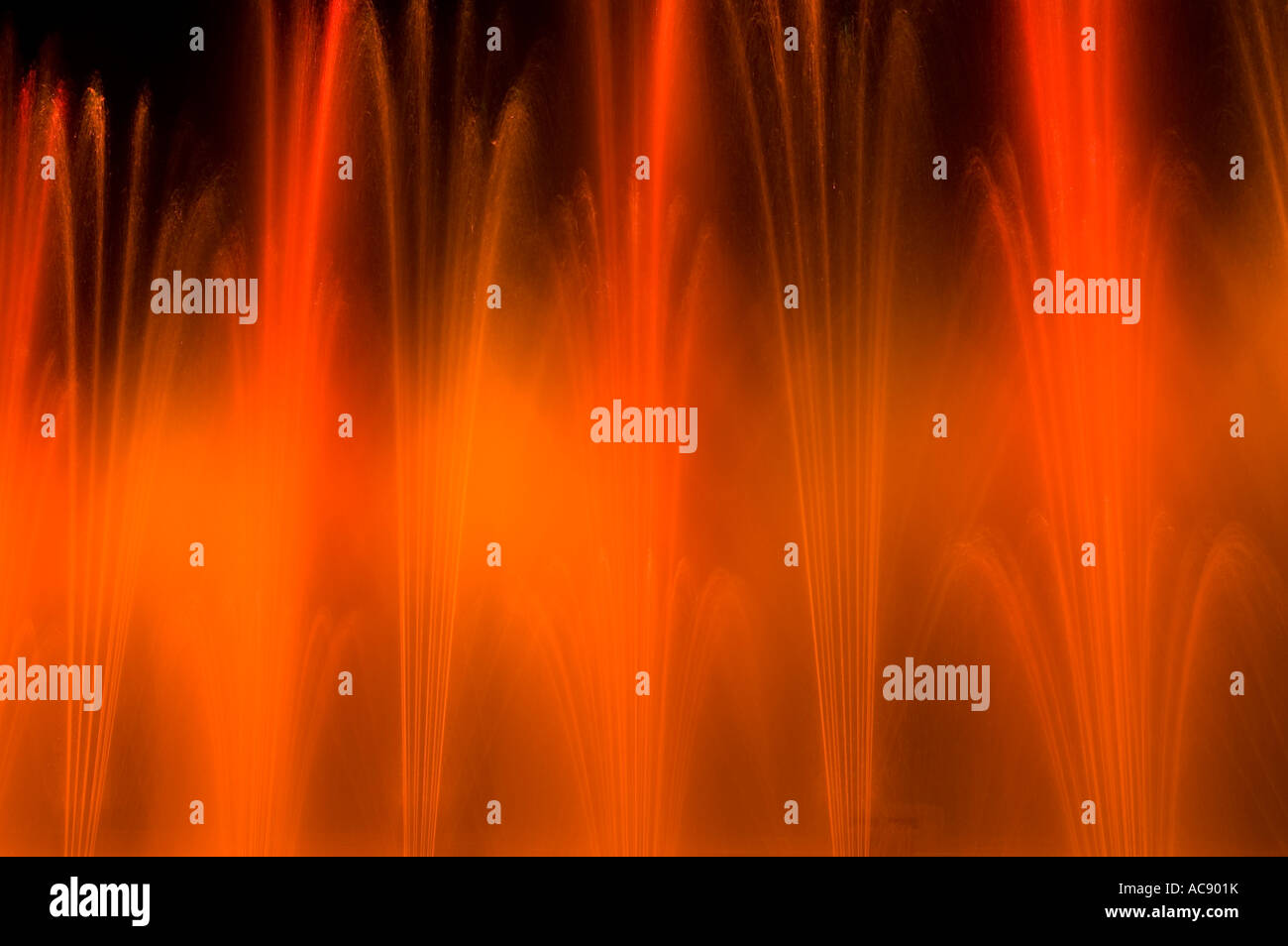 Computer controlled and synchronized water fountains are illuminated by ...