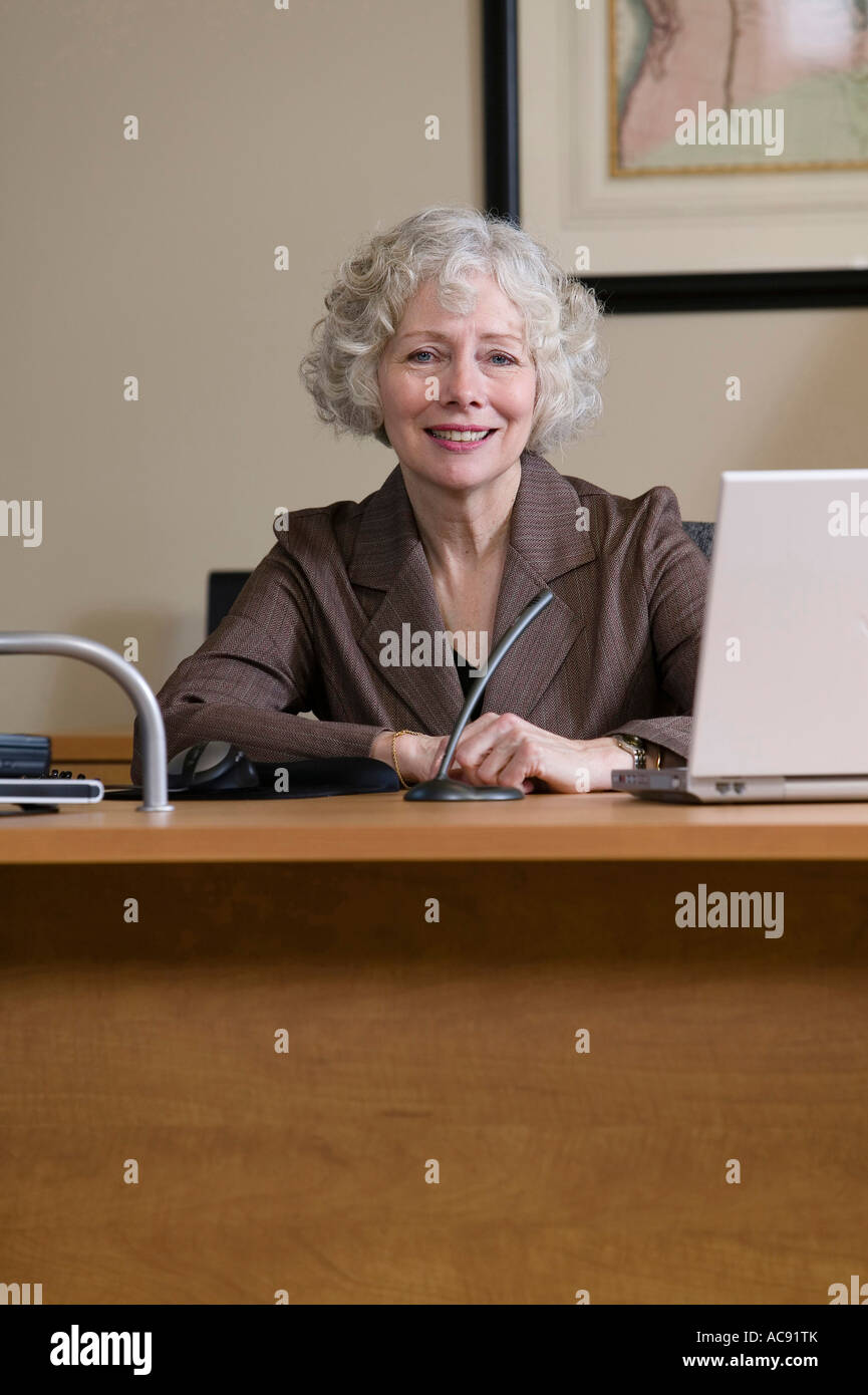 Portrait businesswoman sitting desk hi-res stock photography and images ...