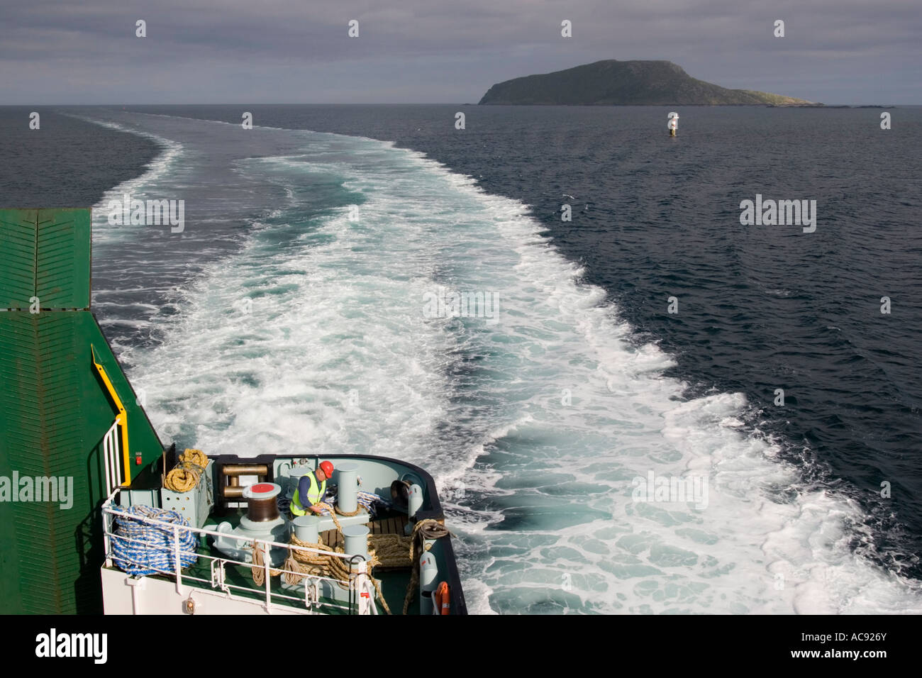 Stern and wake of Calmac Ferry from Oban to Barra with sailor Stock ...