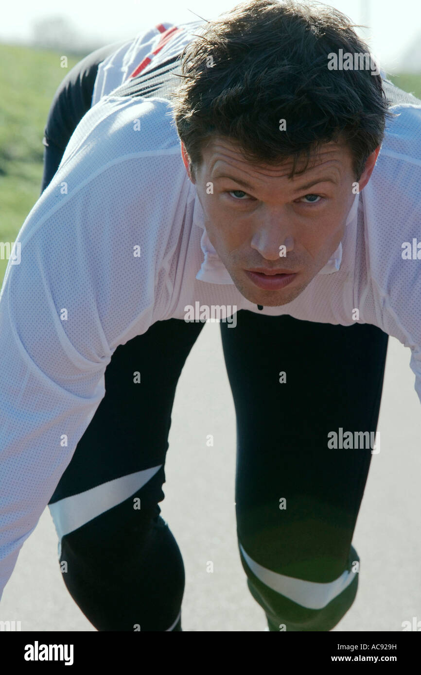 Mid adult man preparing to run Stock Photo - Alamy