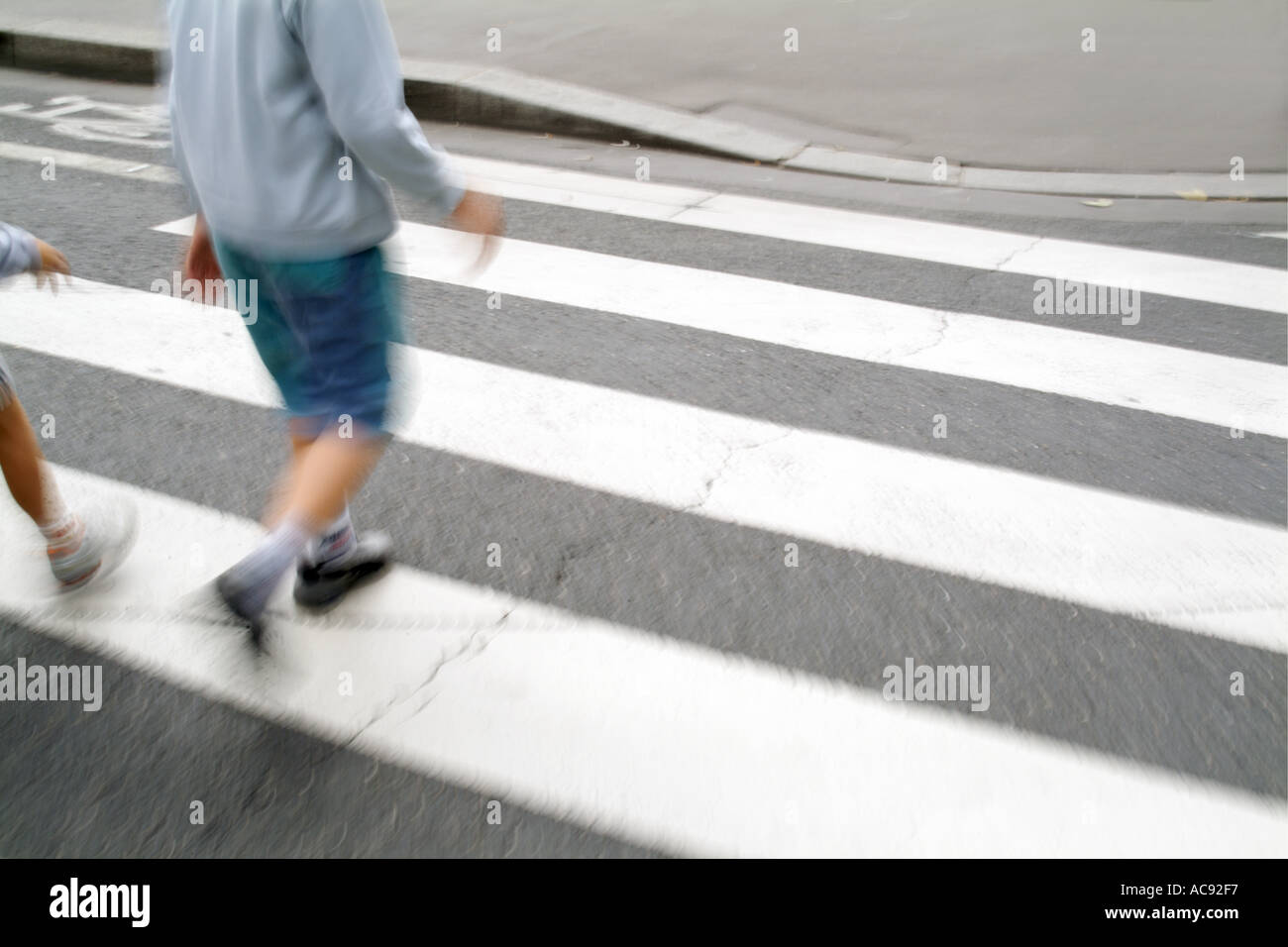 Children walking across a zebra crossing on a city street, Paris ...