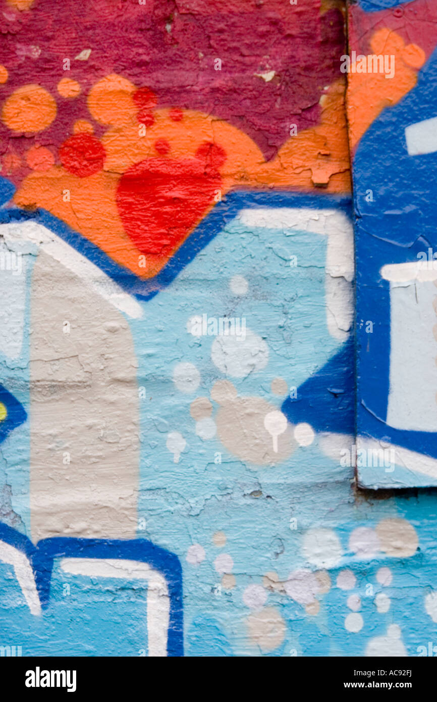 Colourful artistic graffiti painted on derelict walls on waste ground ...