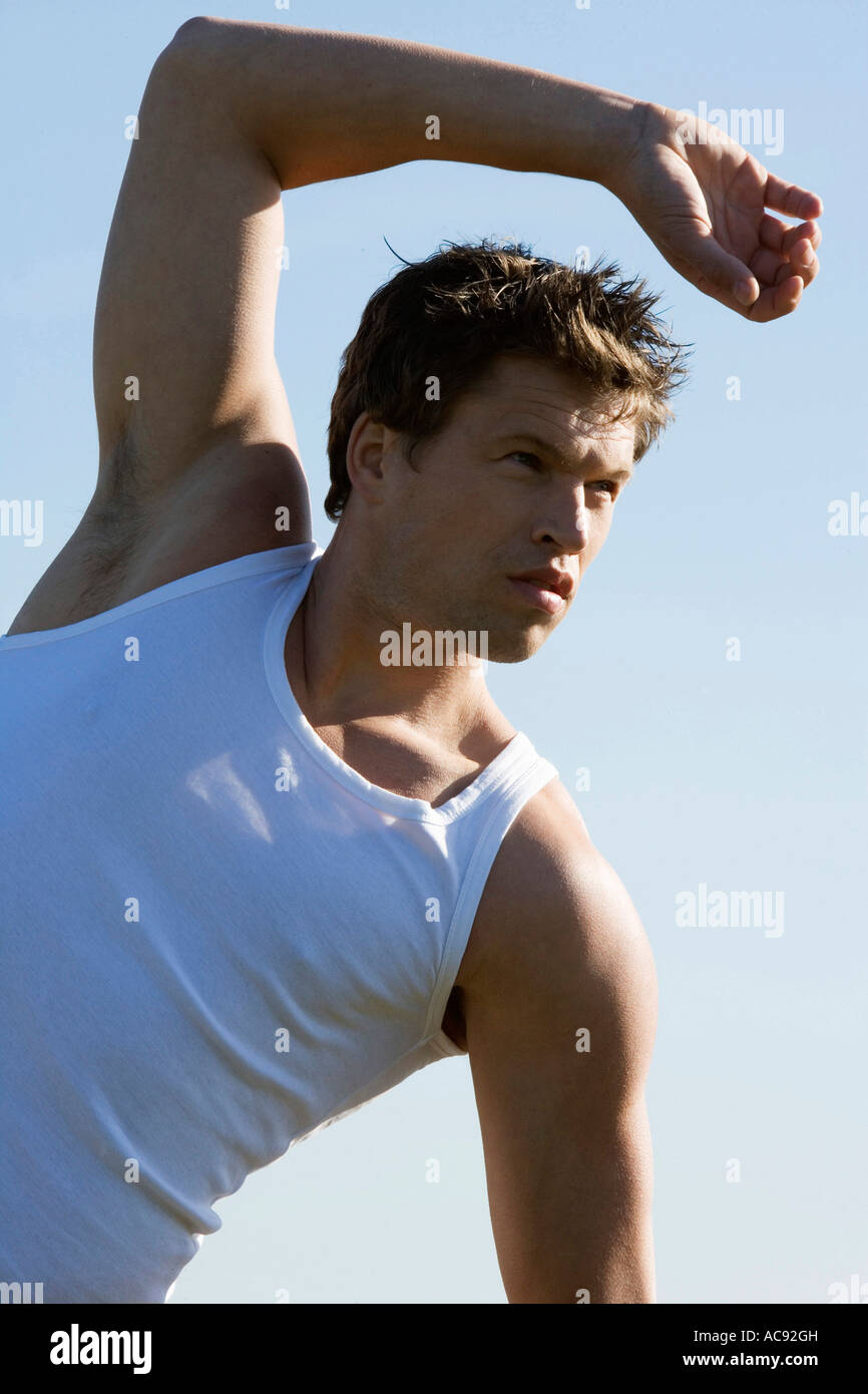 Close-up of a mid adult man stretching Stock Photo - Alamy