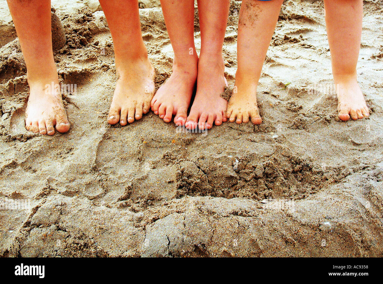 Three Pairs Of Feet Stock Photo - Alamy