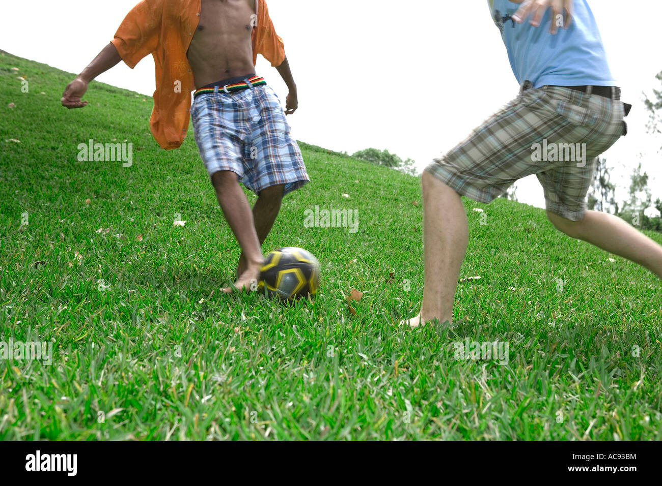Boy chasing a ball hi-res stock photography and images - Alamy