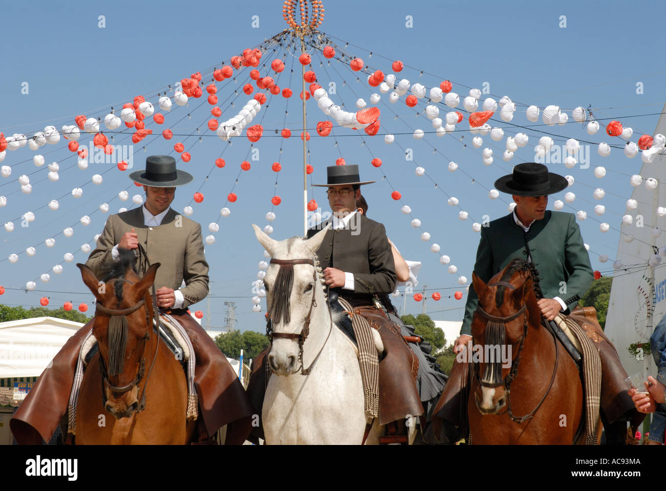 Three horsemen in traditional Spanish equestrian dress on horseback at ...