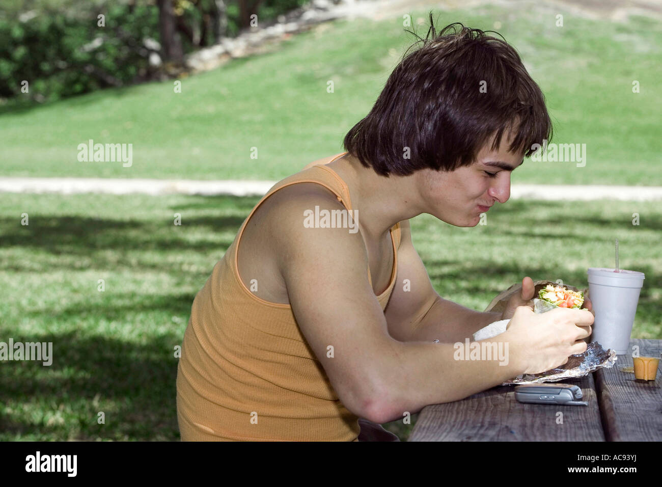 Young man eating Stock Photo - Alamy