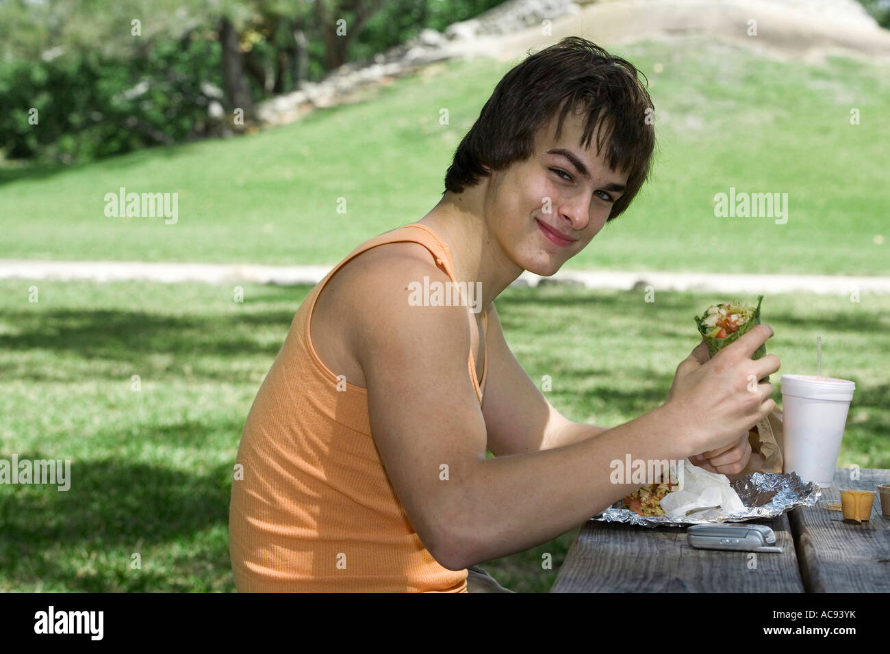 Young man eating Stock Photo - Alamy