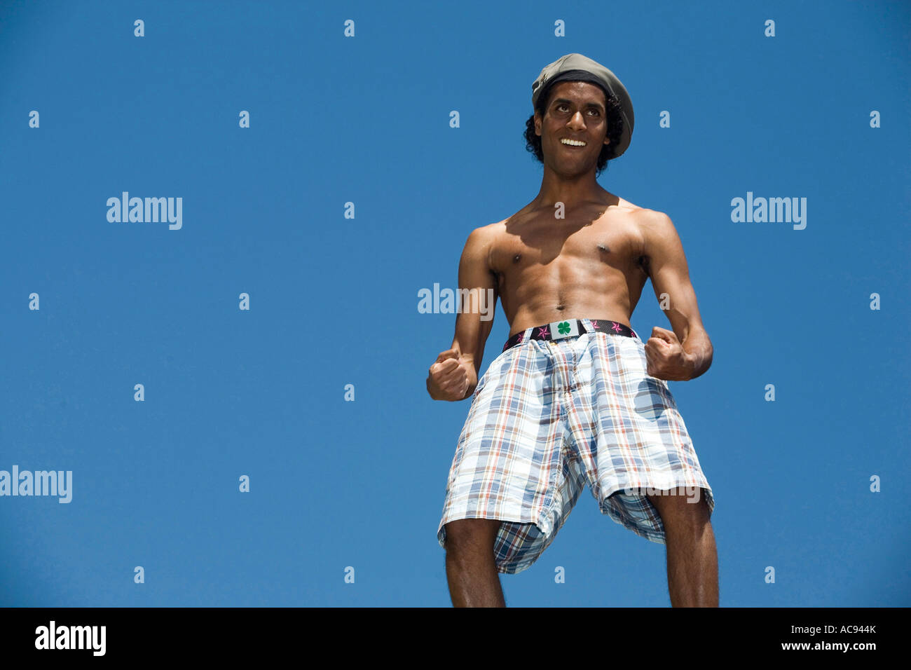 Skinny Man Flexing His Muscles
