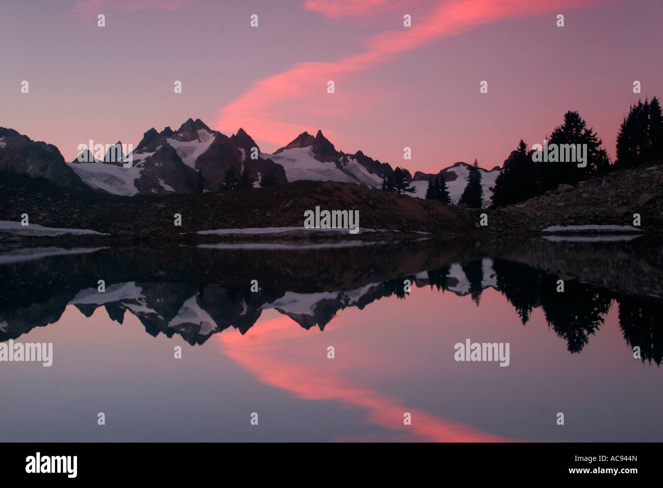 Pink clouds over Mount Hagan reflected in a high alpine lake North ...