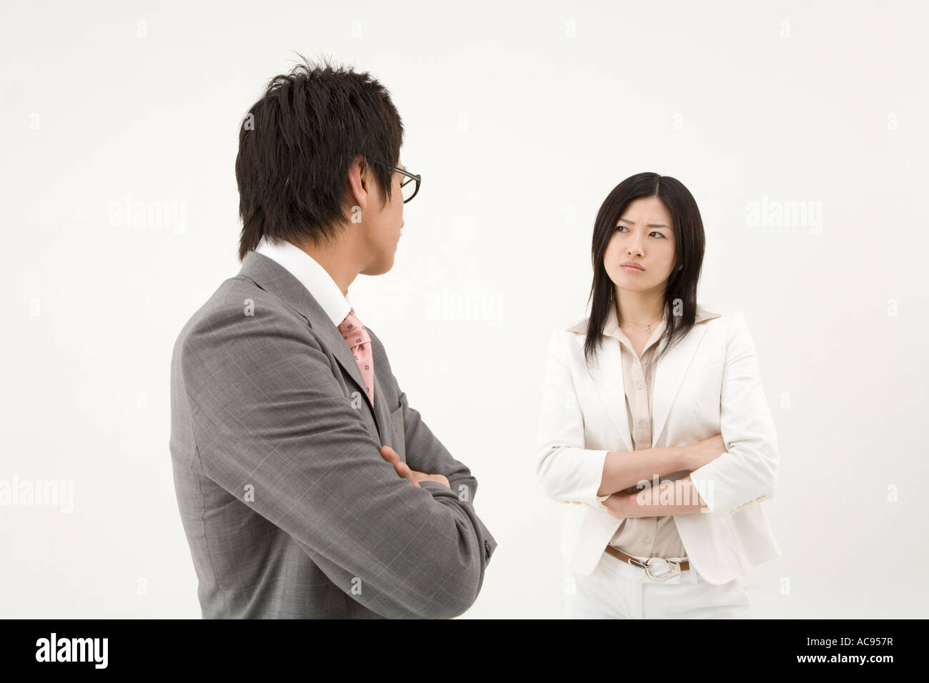 Two business people glaring at each other Stock Photo - Alamy