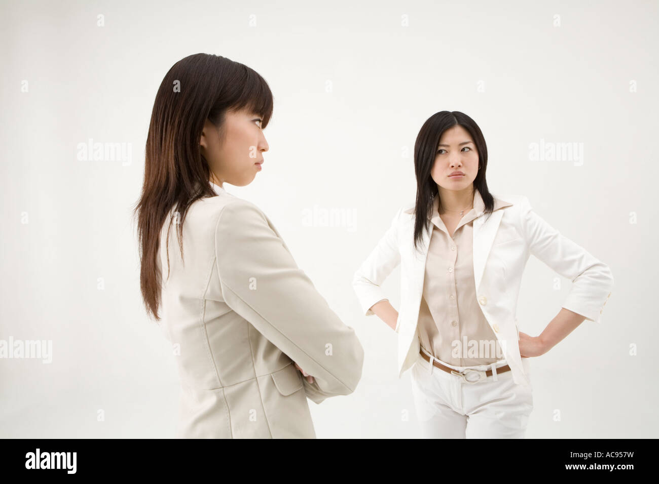 Two businesswomen glaring at each other Stock Photo - Alamy
