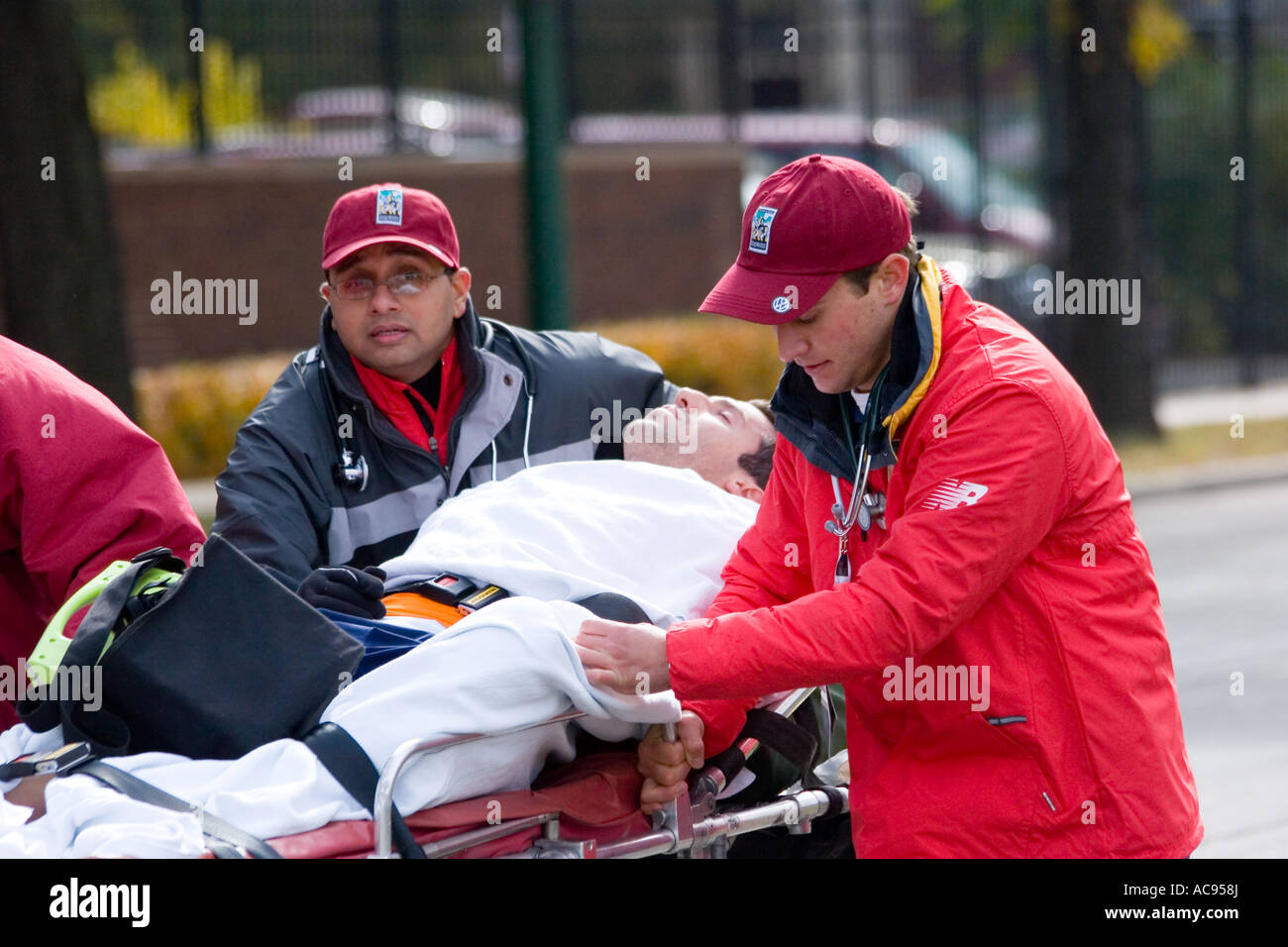 Marathon runner being carried away on a stretcher Stock Photo - Alamy