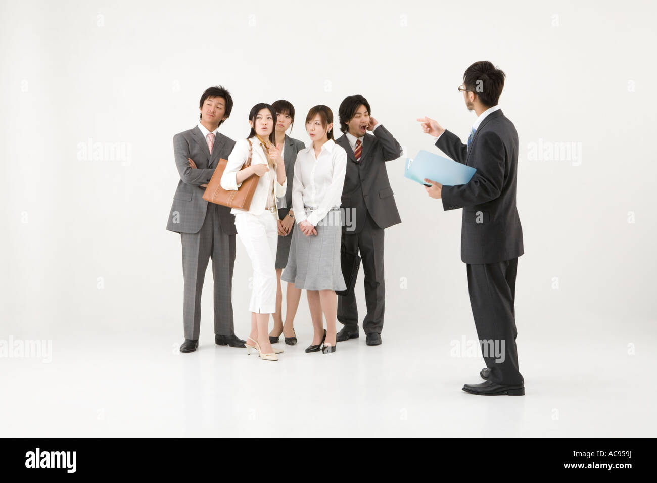 Businessman excluded from group of business people Stock Photo - Alamy