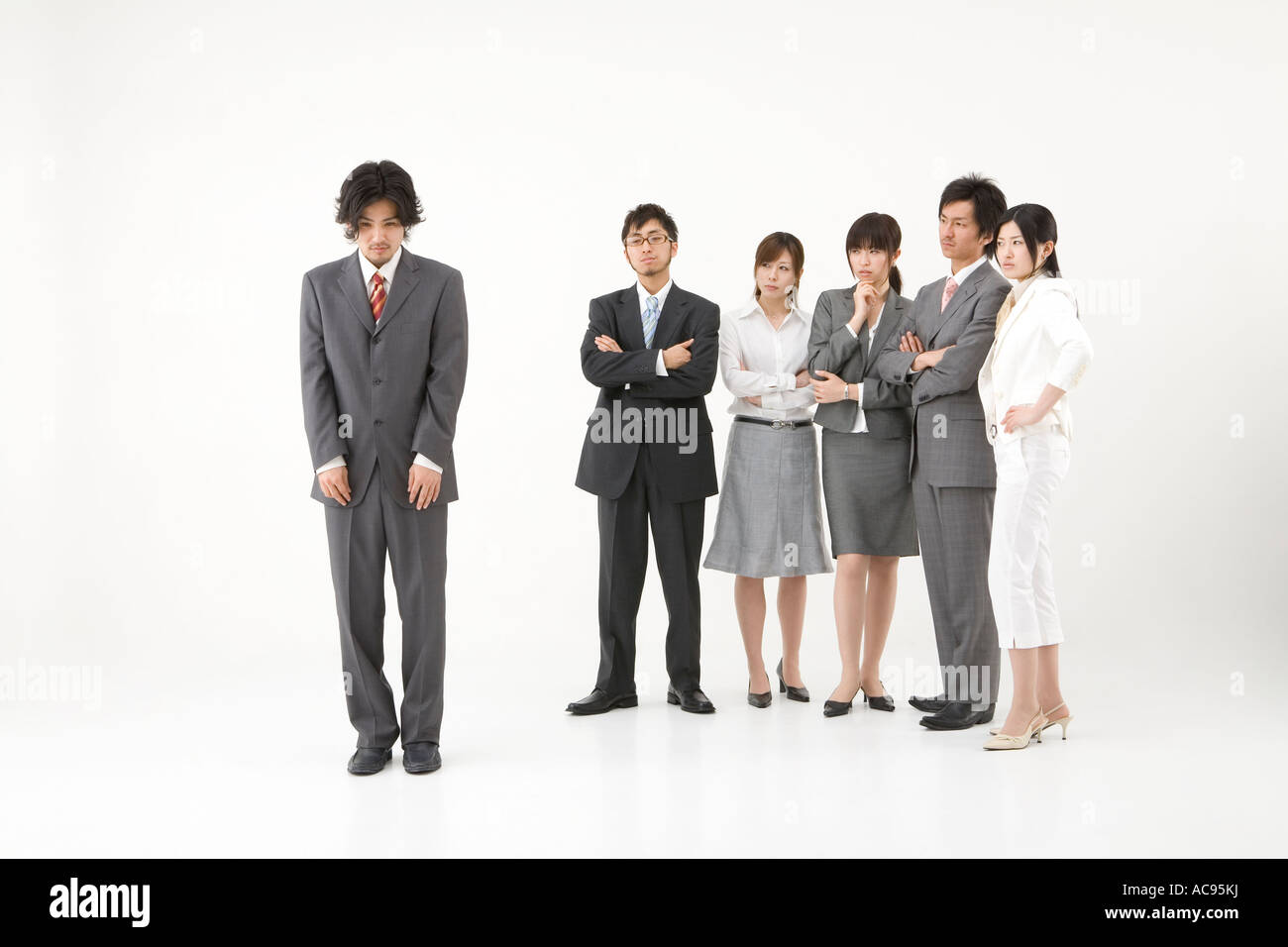 Businessman excluded from group of business people Stock Photo - Alamy