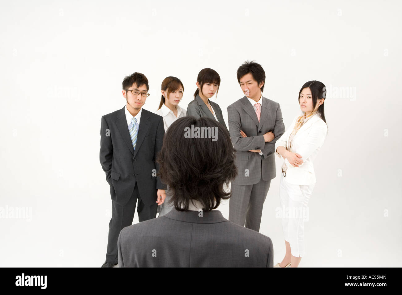 Businessman excluded from group of business people Stock Photo - Alamy