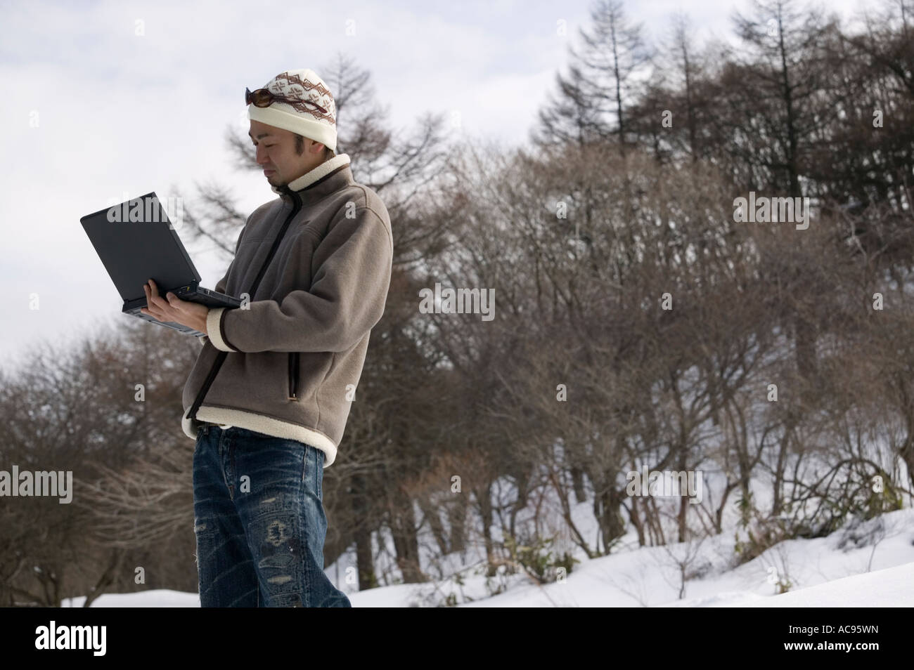 Young man using computer outside Stock Photo - Alamy