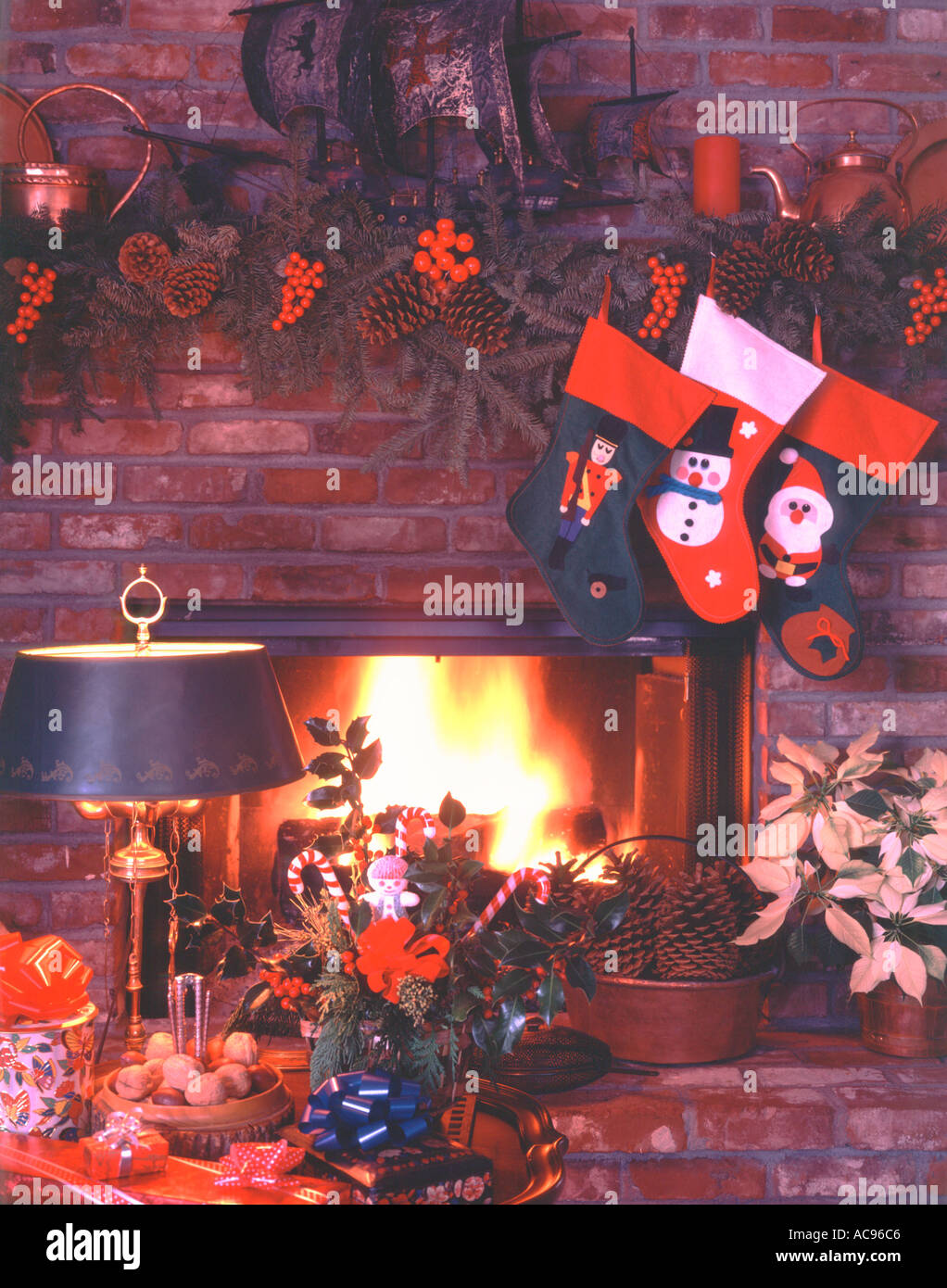 Christmas seasonal still life with burning fireplace stockings and ...