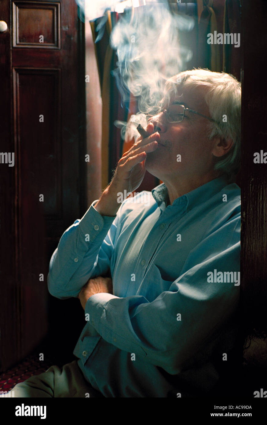Man enjoying smoking a good cigar Stock Photo - Alamy