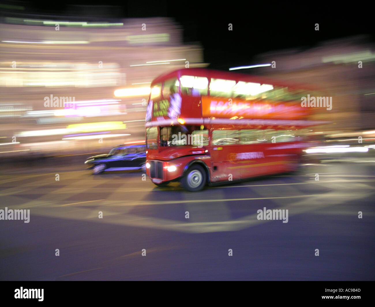Blur of a red double decker bus at night in London England UK Britain ...